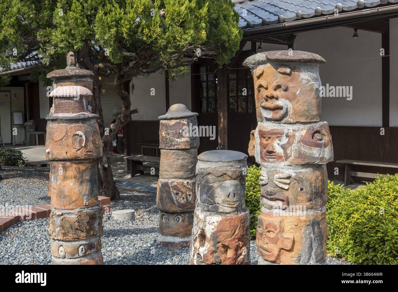 Ceramic columns with faces in a traditional Japanese courtyard Stock ...