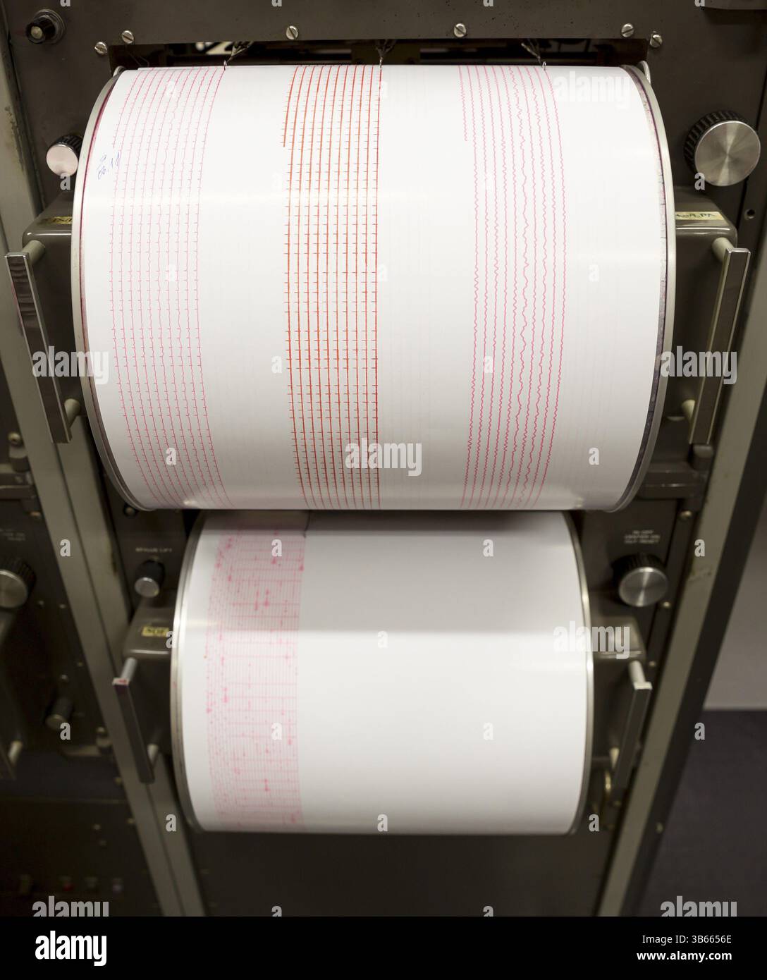 Seismograph records an earthquake on the sheet of measuring paper ...