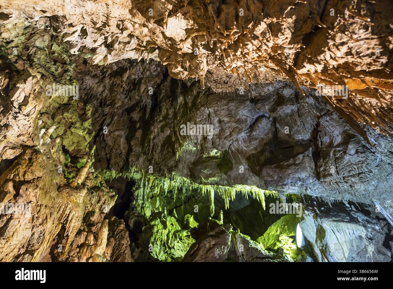 Inside of a beautiful colourful cave. Flowstones, stalactites and ...