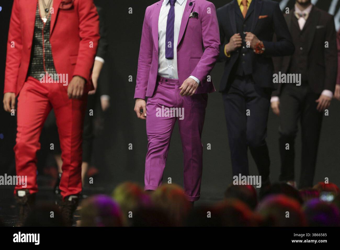 Male models walk the runway in beautiful red and pink suits during a ...