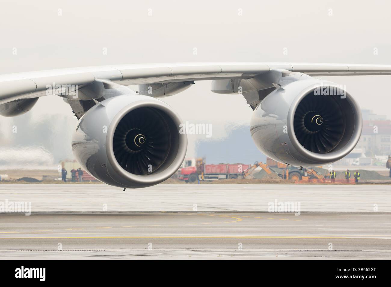 Airbus A380 airplane's engines on a wing on a runway at an airport ...