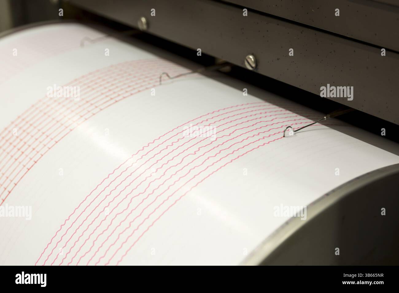 Seismograph records an earthquake on the sheet of measuring paper ...