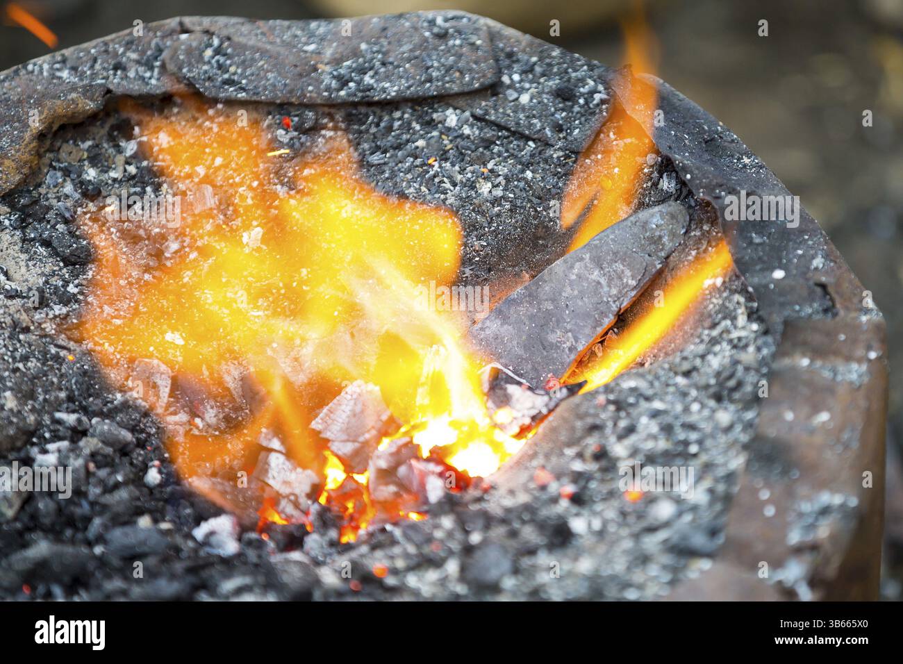Hot metal arrow blade in the fire before being hammered by a blacksmith ...