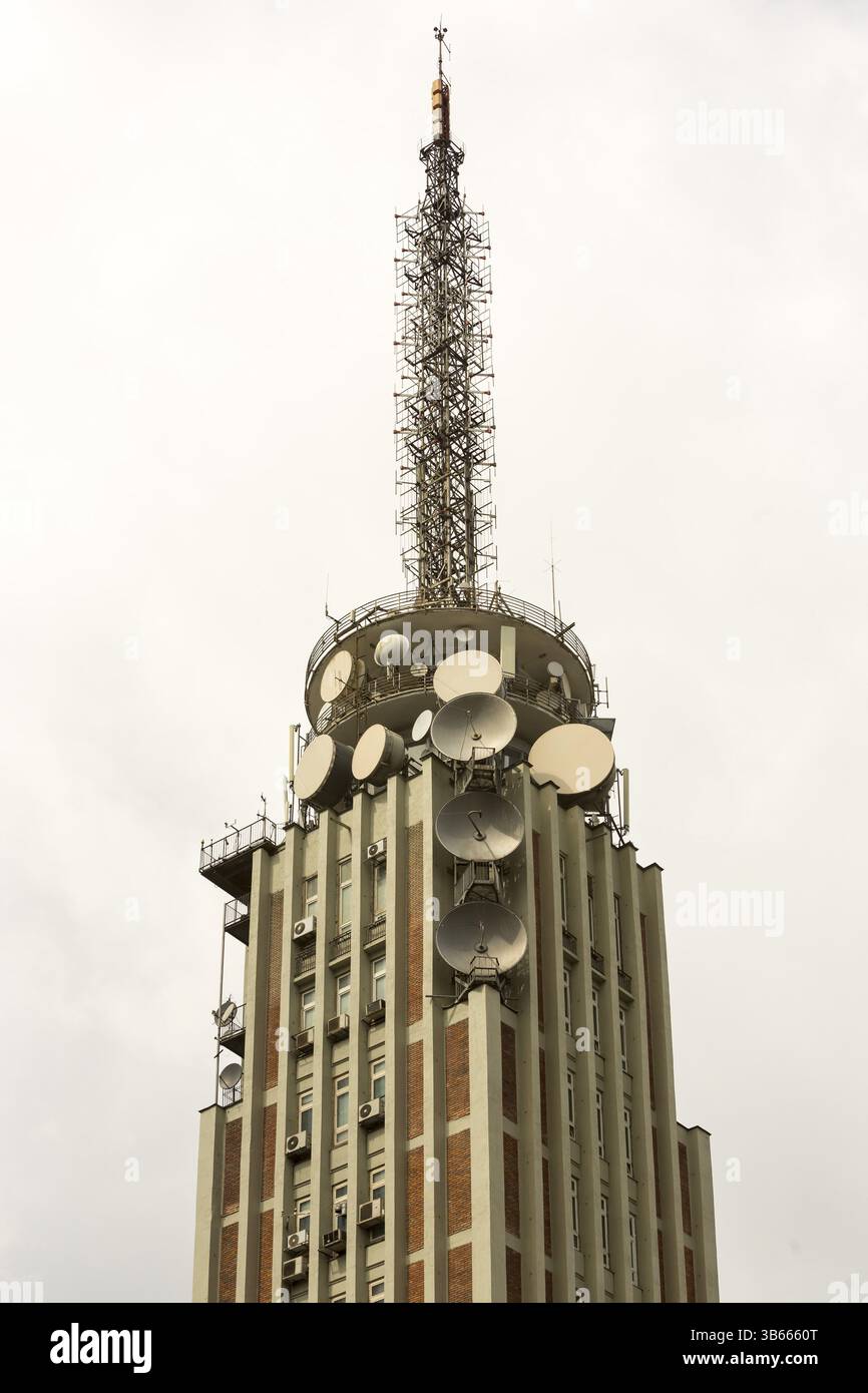 Old television broadcast tower with satellite dishes and communication ...