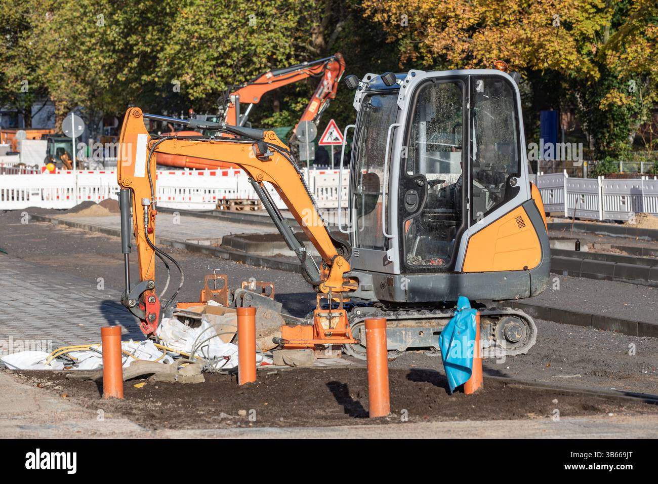 small excavator on a road construction site Stock Photo - Alamy