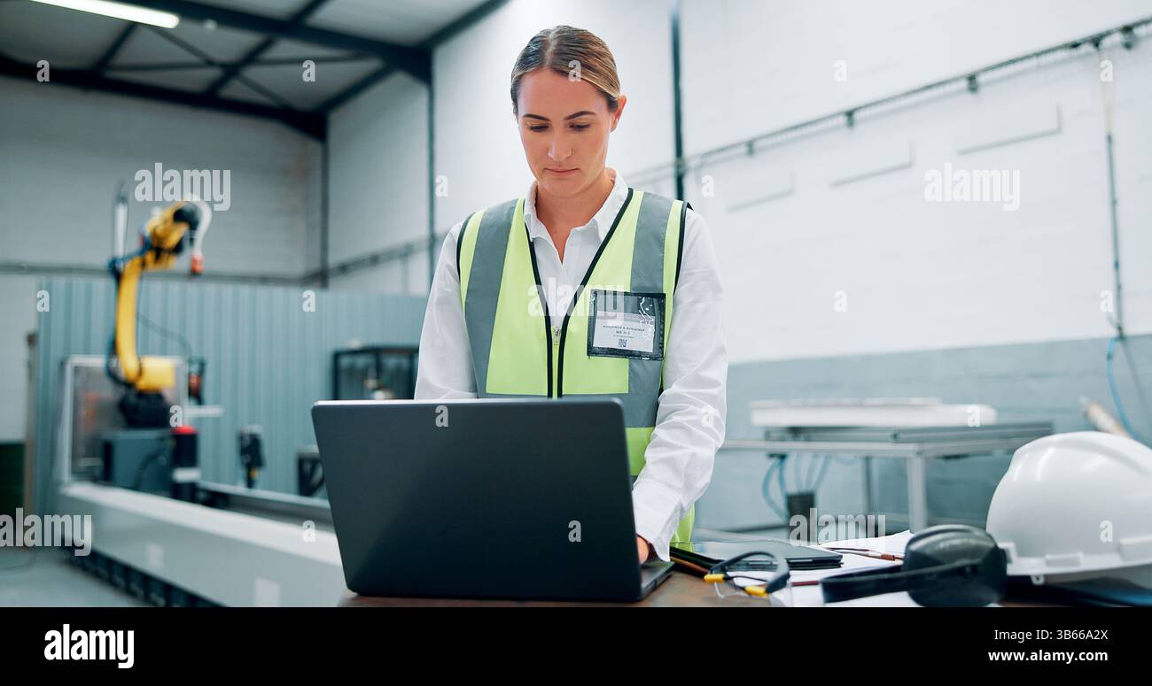 Engineer, laptop and woman with robotics for manufacturing or assembly ...