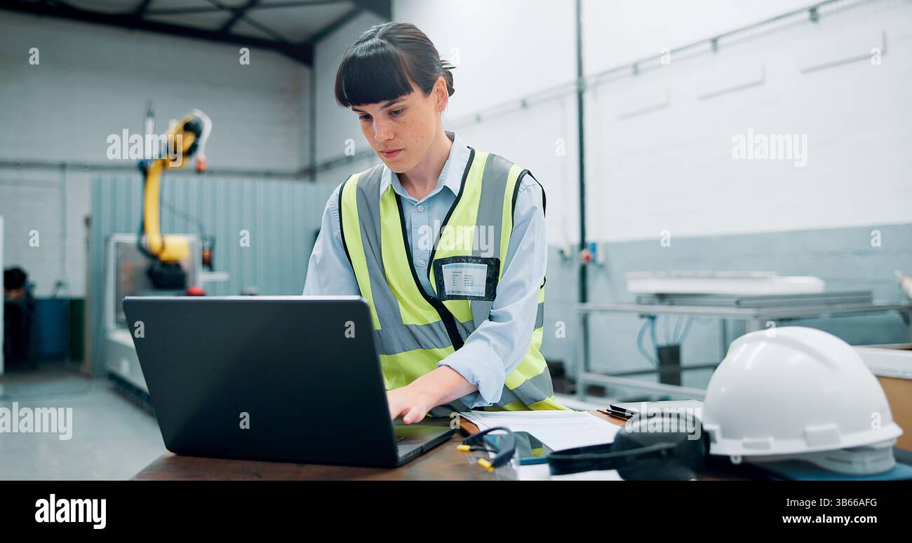 Engineer, laptop and woman with robotics for production at assembly ...