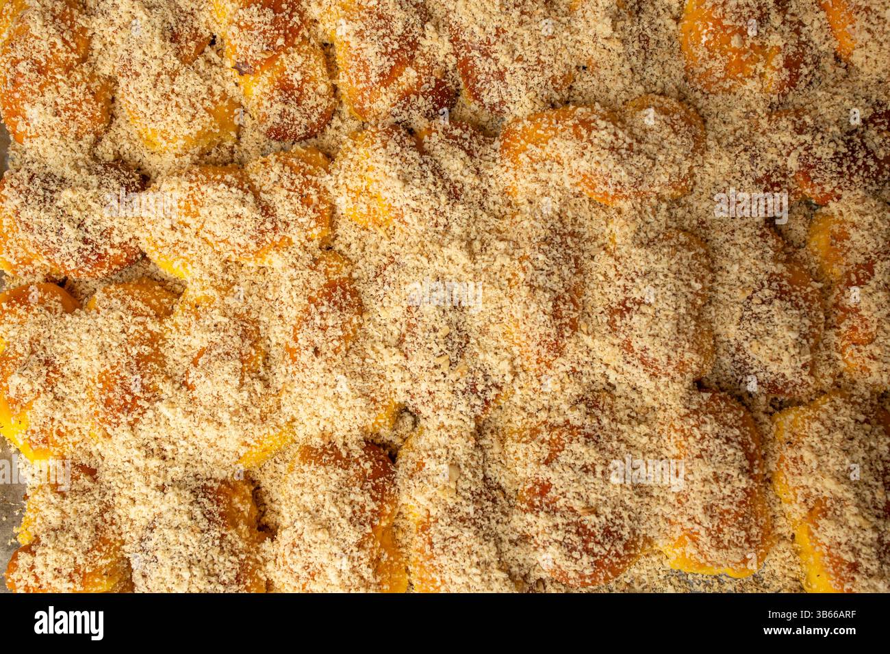 Sprinkling grated nuts on sfintisori .Romanian cuisine. Homemade ...
