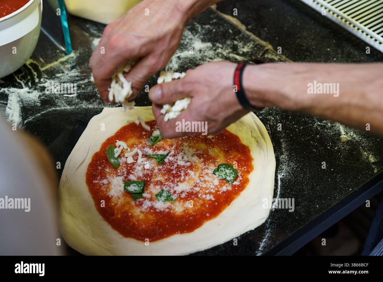 Chef sprinkles pizza mozzarella cheese hi-res stock photography and ...