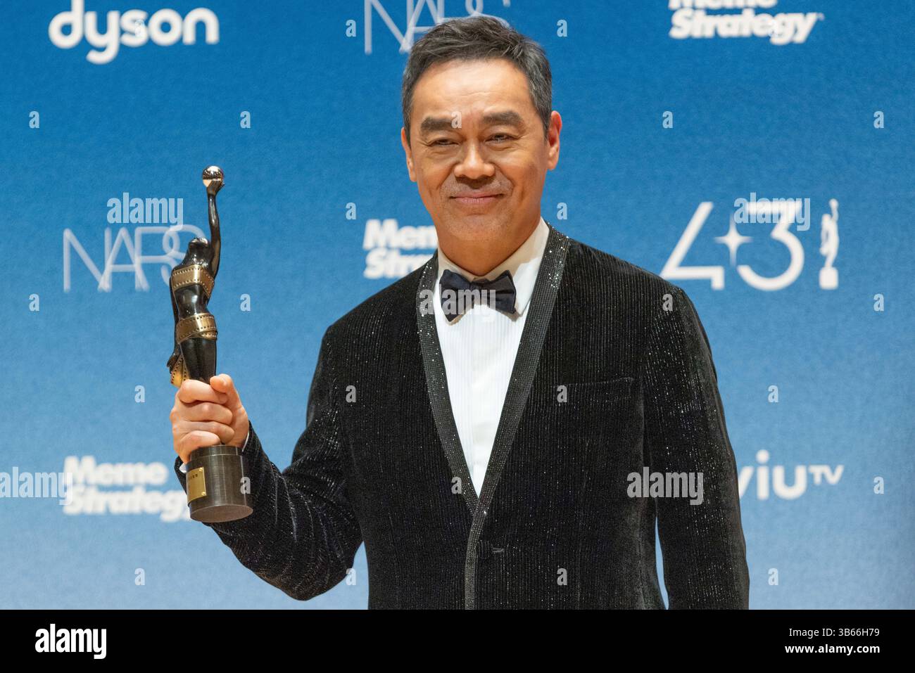 Hong Kong Sean Lau, winner of Best Actor for the movie Papa, poses with ...