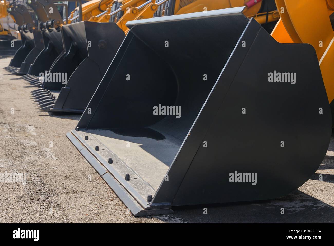 Backhoe buckets in the parking lot. Construction equipment Stock Photo ...