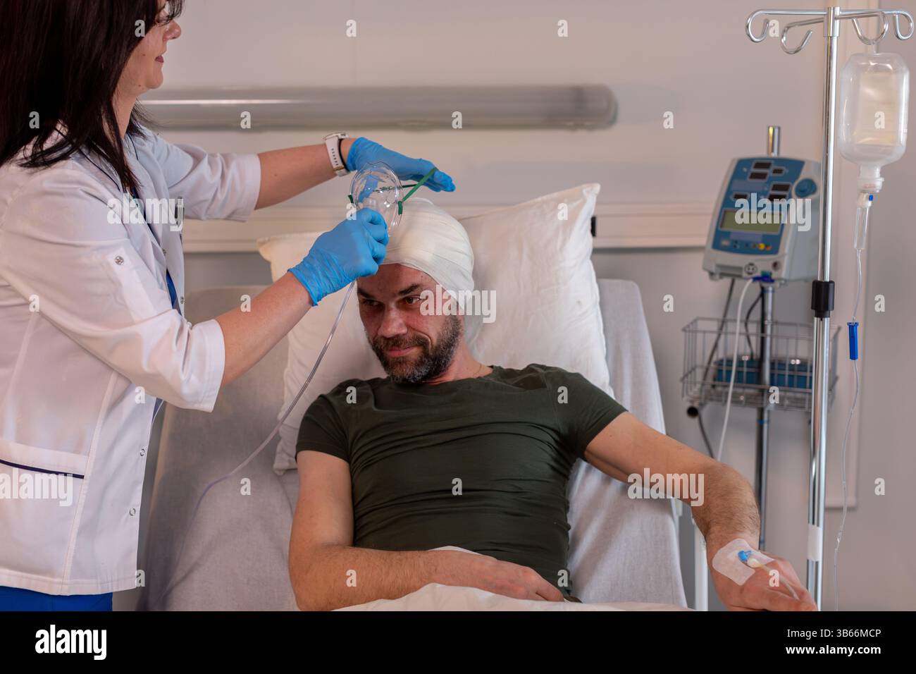 A patient is currently receiving medical care and attention in a hospital room setup Stock Photo ...