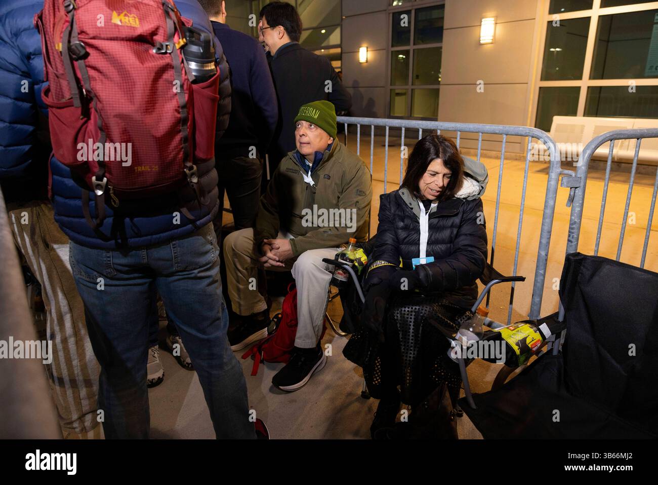 Daryl Paunil, left, of Silver Spring, Md., waits in line beside Ilene ...