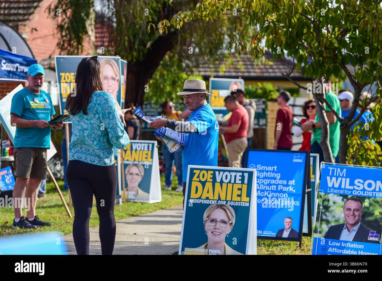 Liberal party volunteer seen handing out flyers to the voters at the ...