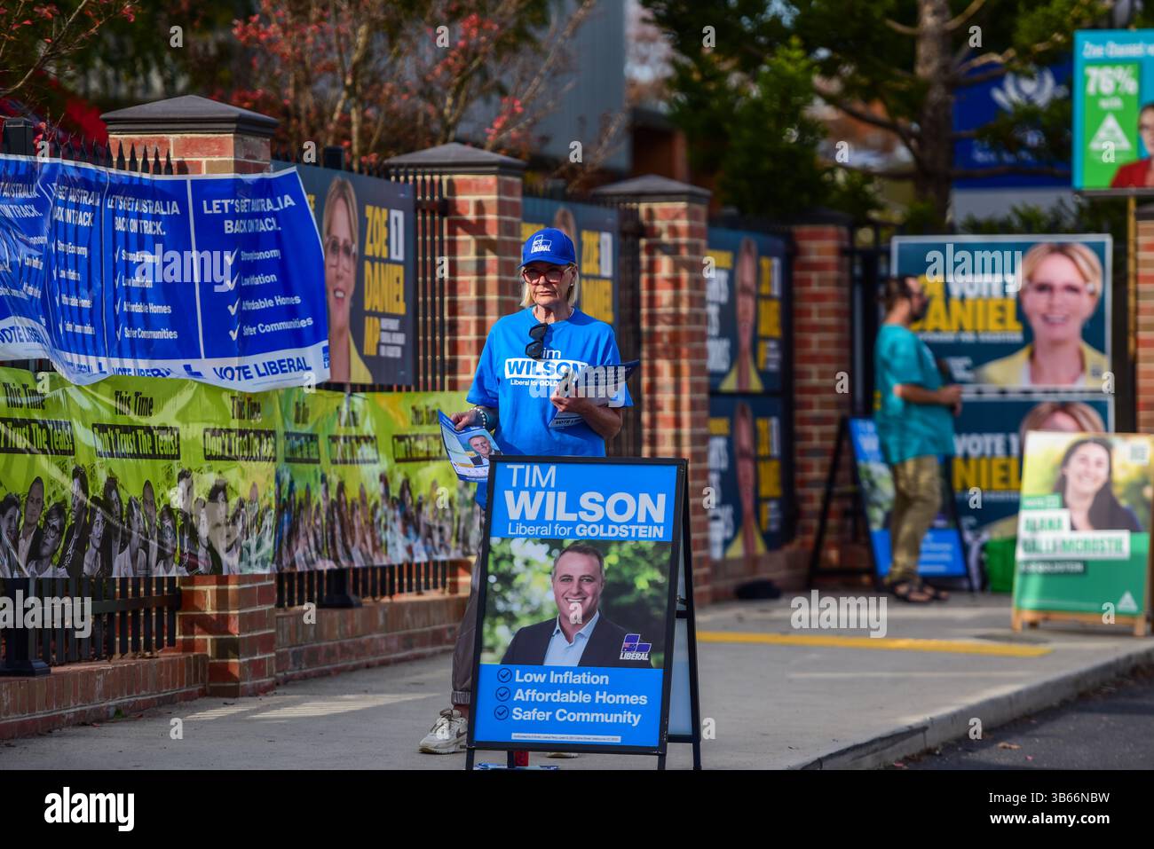 Volunteer for the Liberal party seen with flyers at the polling station ...