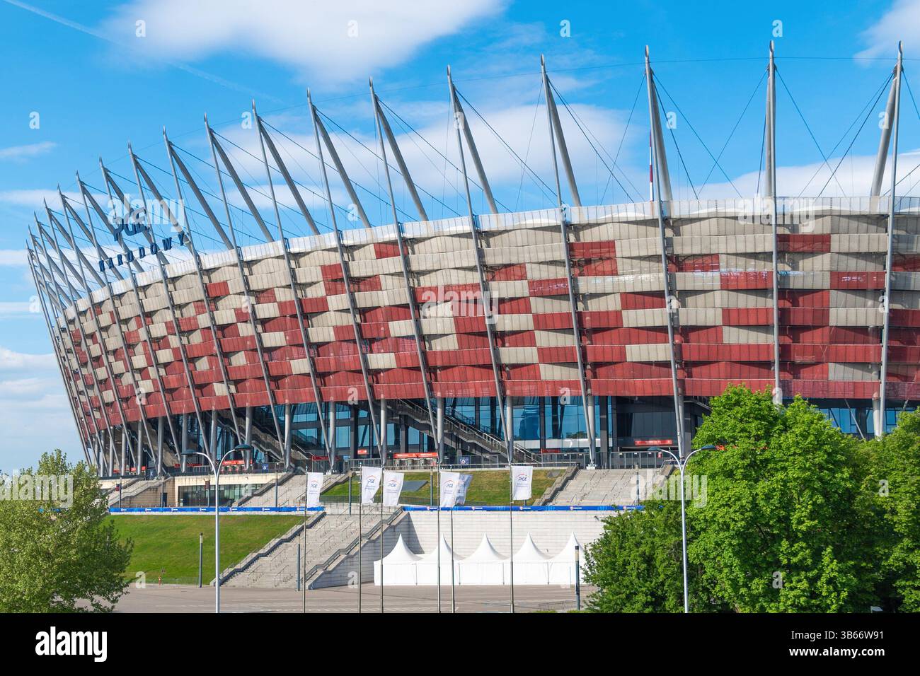 Modern multi-colored stadium with architectural design under blue sky ...