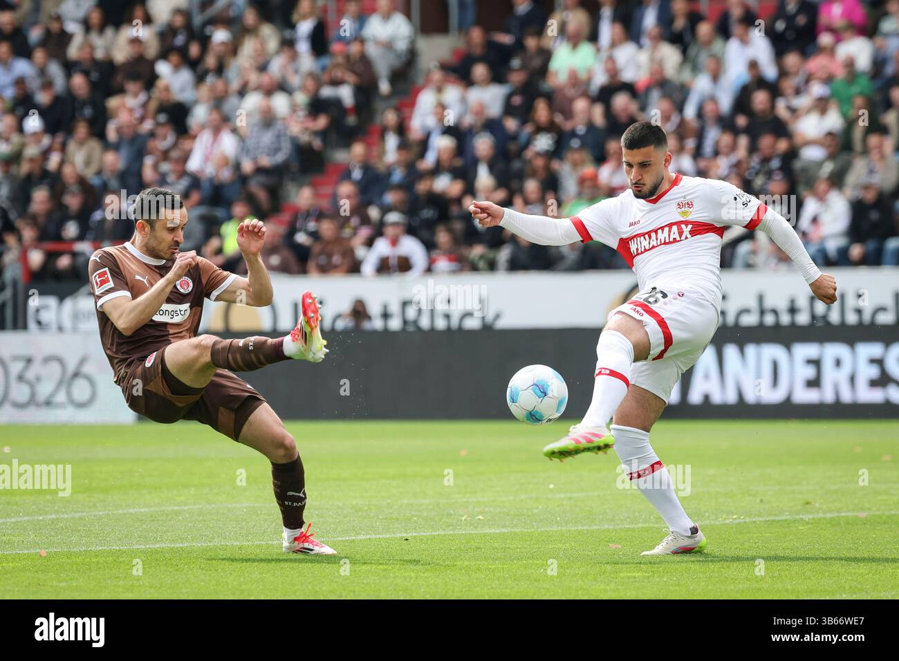 St. Pauli's Manolis Saliakas, left, and Stuttgart's Deniz Undav ...