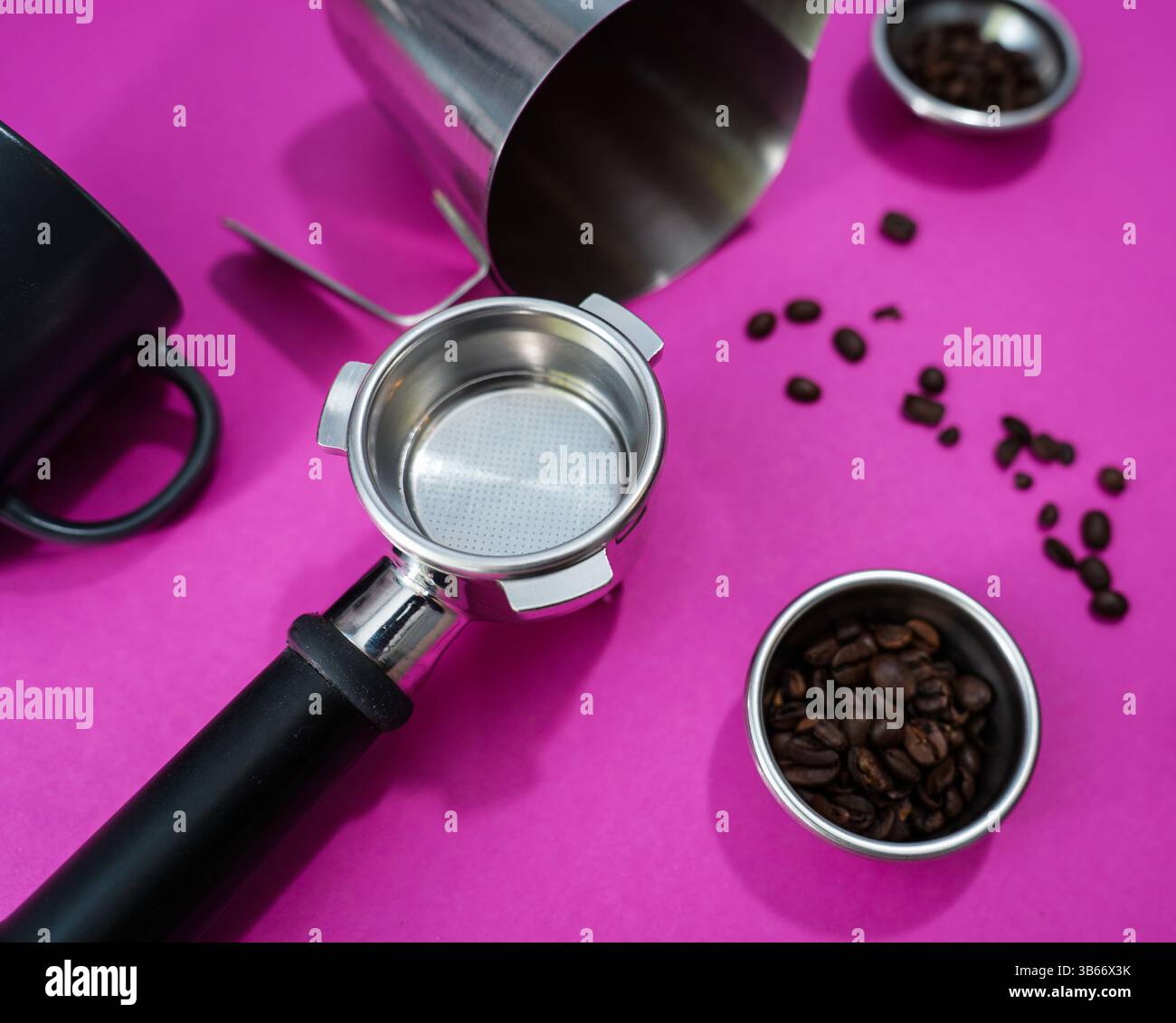Portafilter, beans, and barista tools on vibrant pink background ...