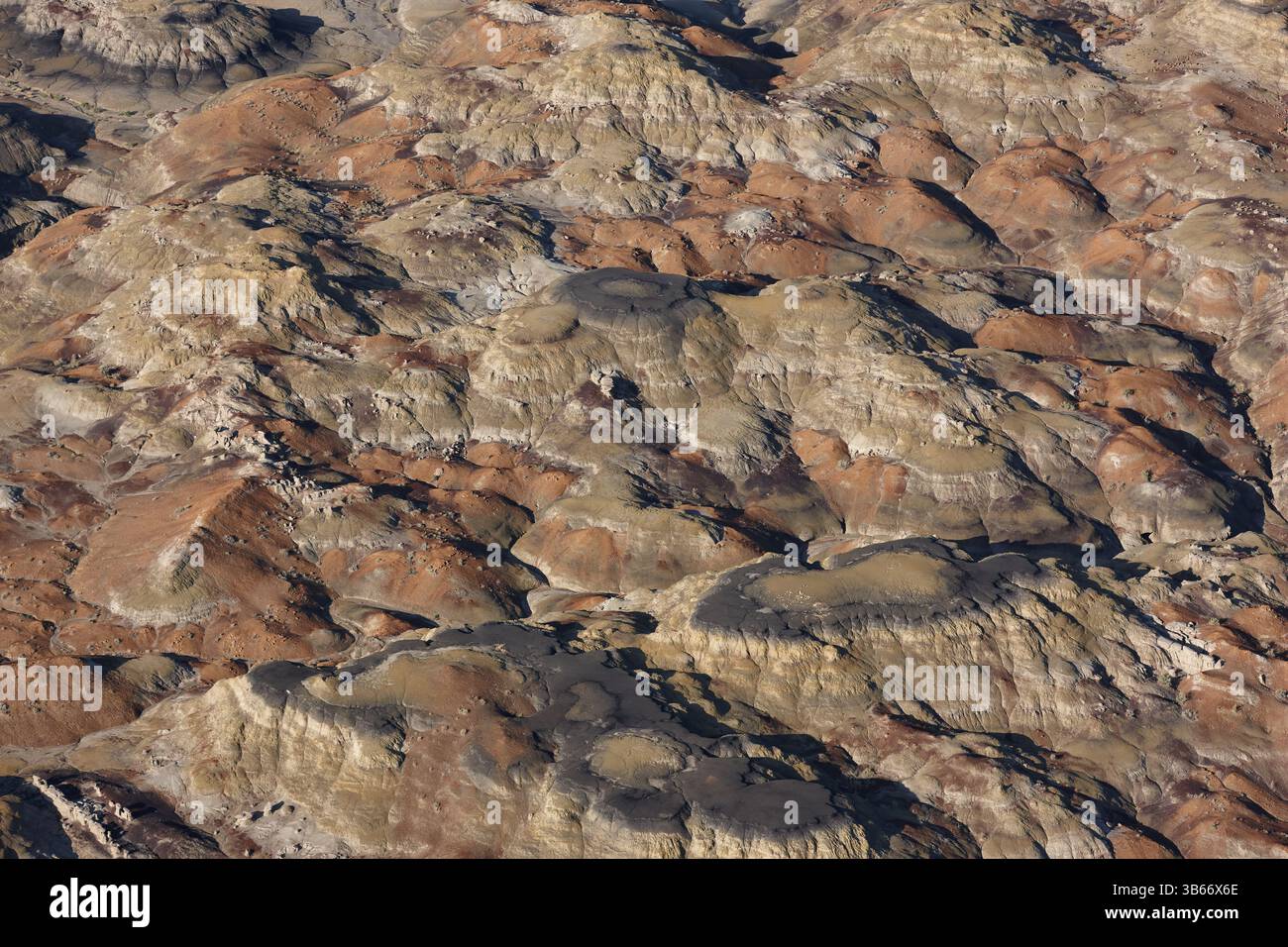 AERIAL VIEW. Badlands of sedimentary rock with colorful strata. Bisti ...