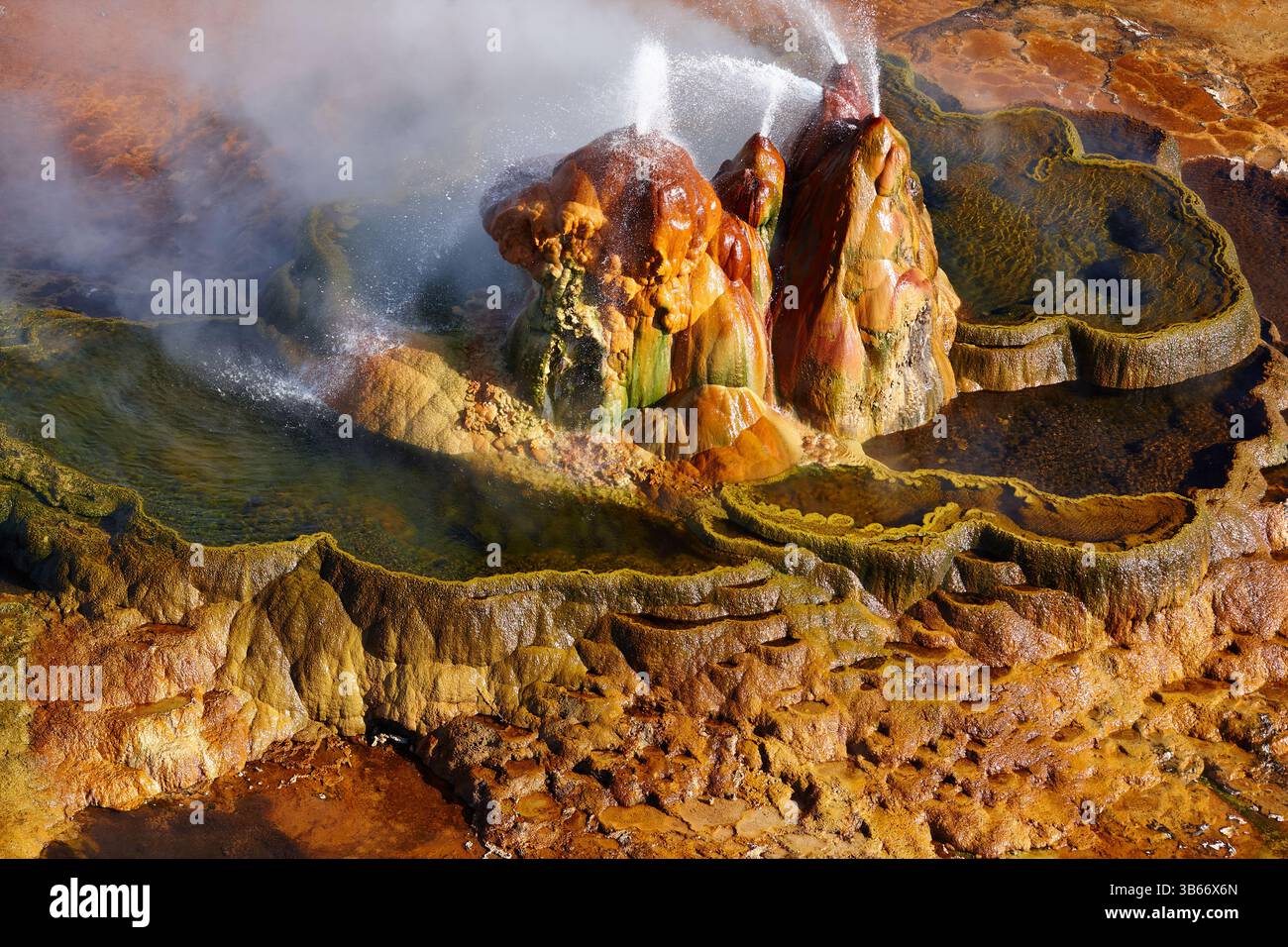 AERIAL VIEW. Fly Geyser is a geothermal rock formation brightly colored ...