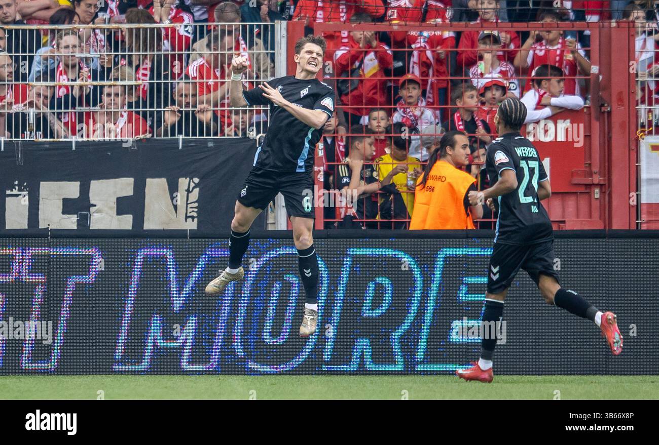 Werder's Jens Stage, centre, celebrates after scoring the opening goal ...