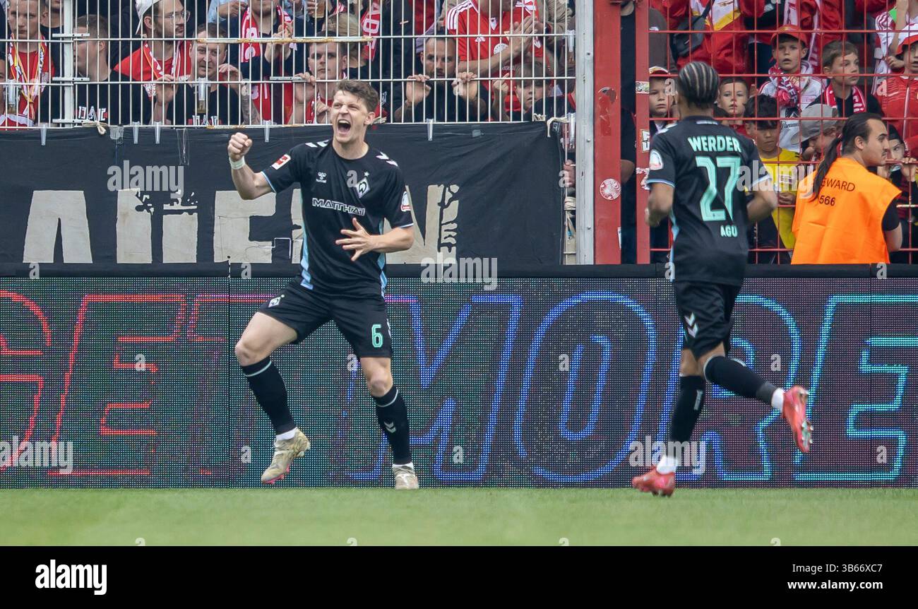 Werder's Jens Stage, centre, celebrates after scoring the opening goal ...