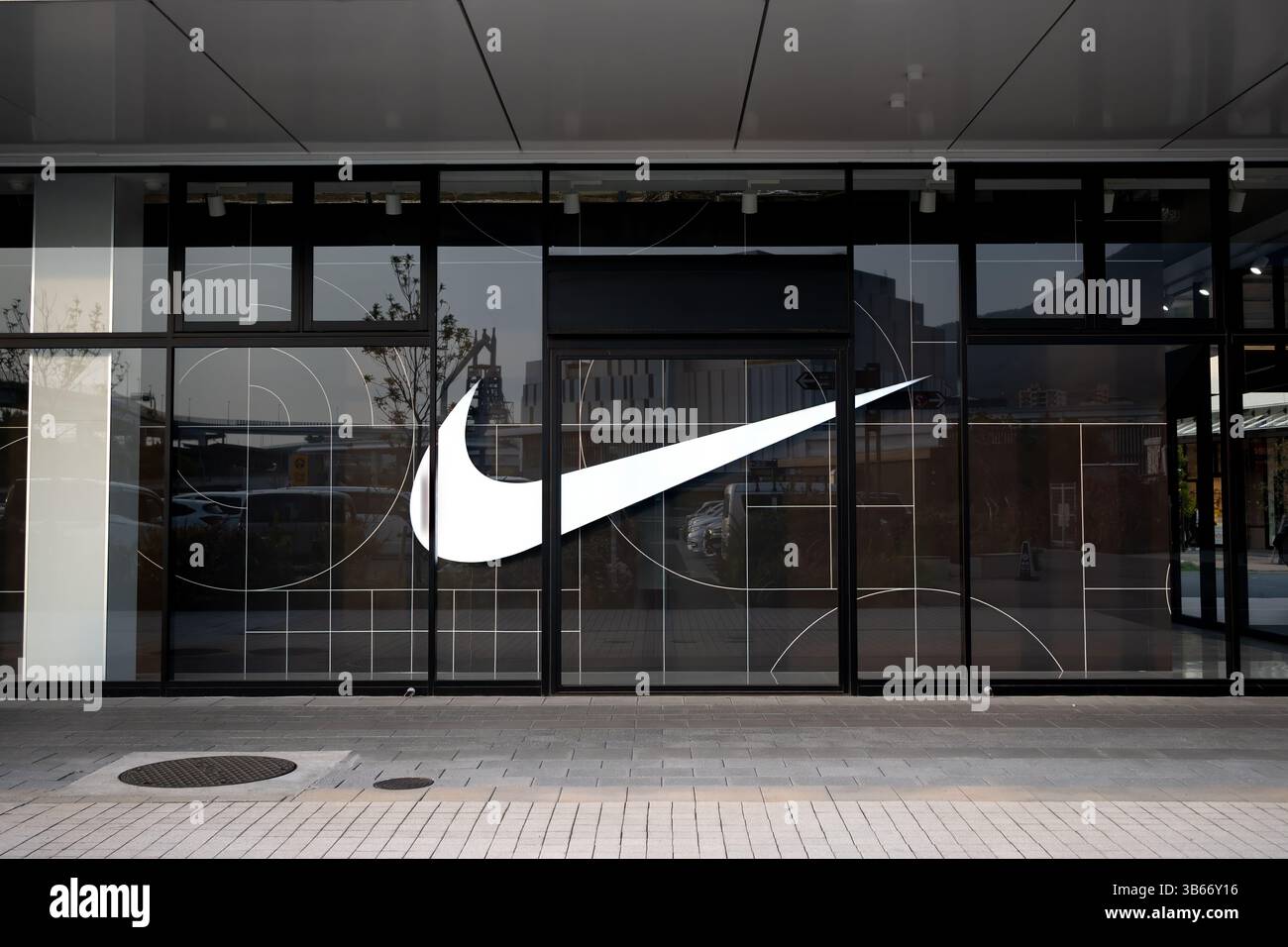 Nike storefront logo on the building of an outlet store Stock Photo - Alamy