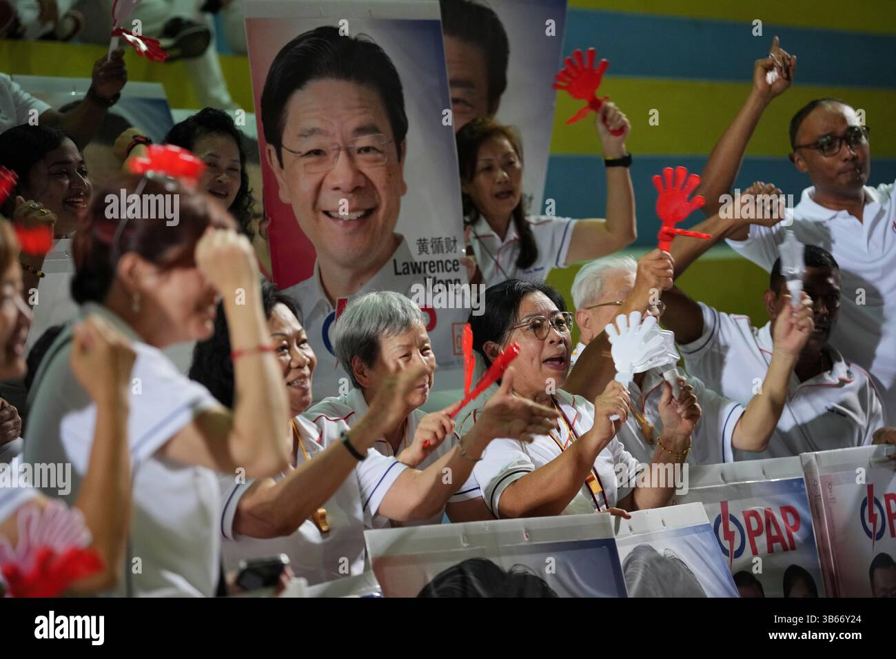 Supporters of ruling party People's Action Party (PAP) cheer as they ...