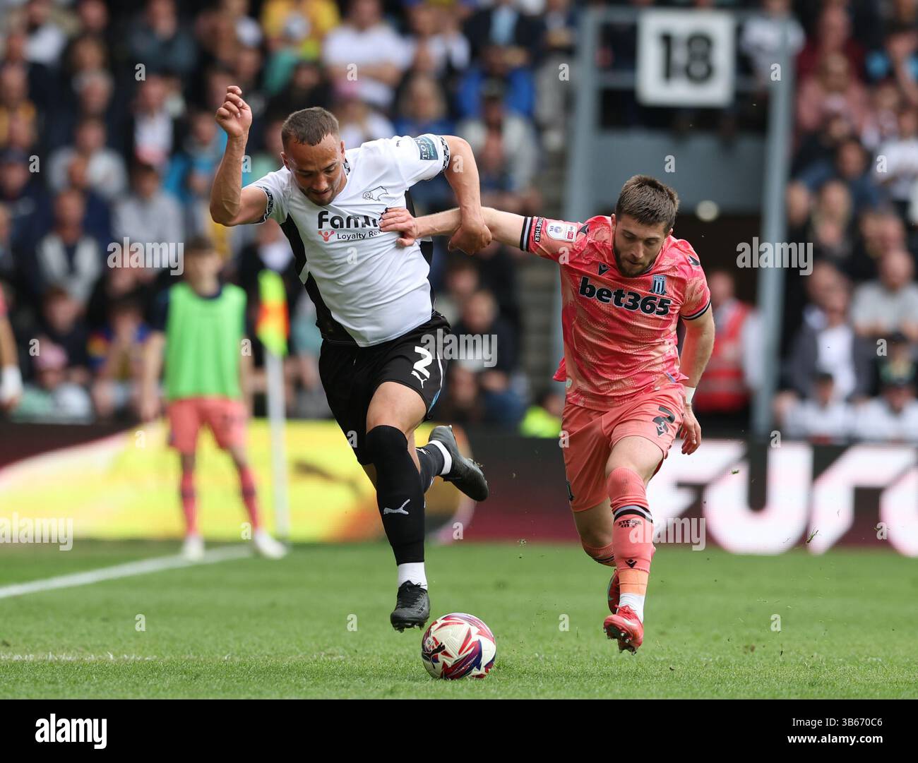 Derby County's Kane Wilson (left) and Stoke City's Lynden Goochbattle ...