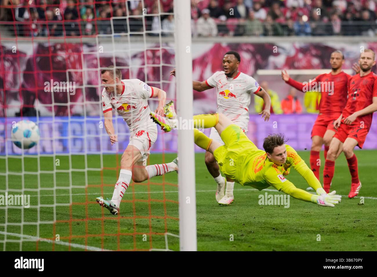Leipzig's Lukas Klostermann, background left, scores his side's second ...