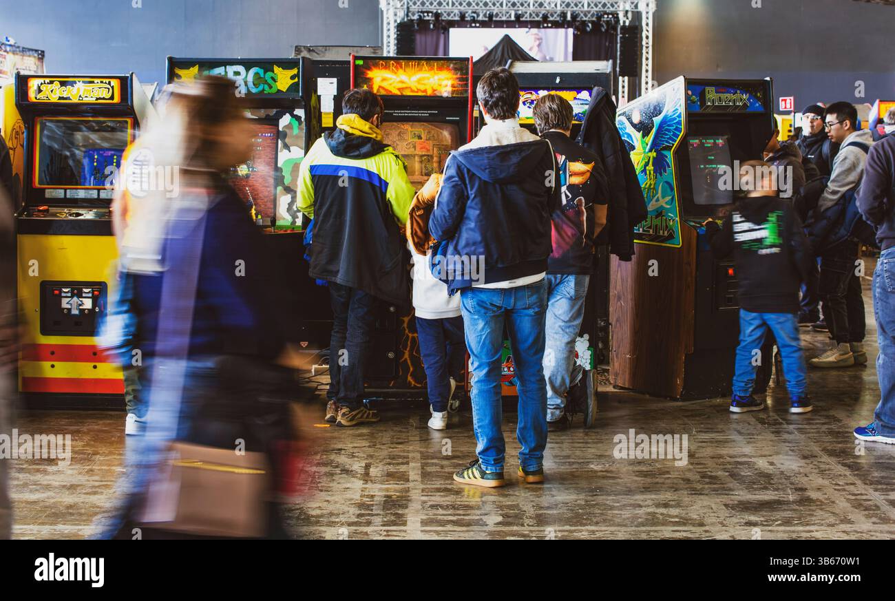 People Playing Retro Arcade Games at Genova Megacom Expo 2025 Stock ...