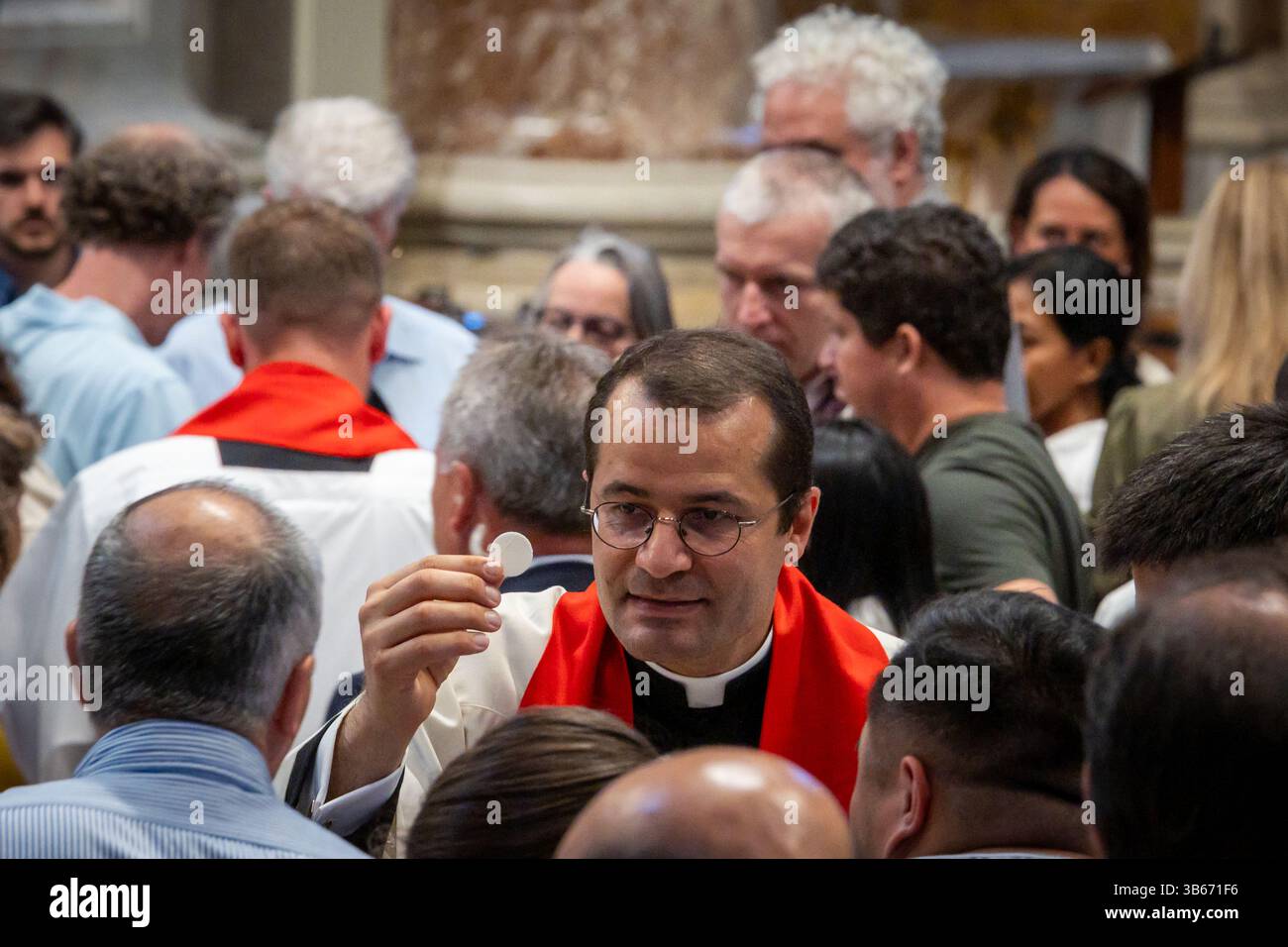Vatican City - April 30, 2025: The faithful receive the host from the ...