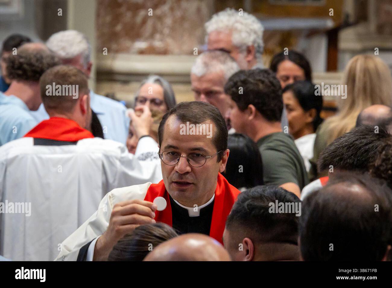 Vatican City - April 30, 2025: The faithful receive the host from the ...