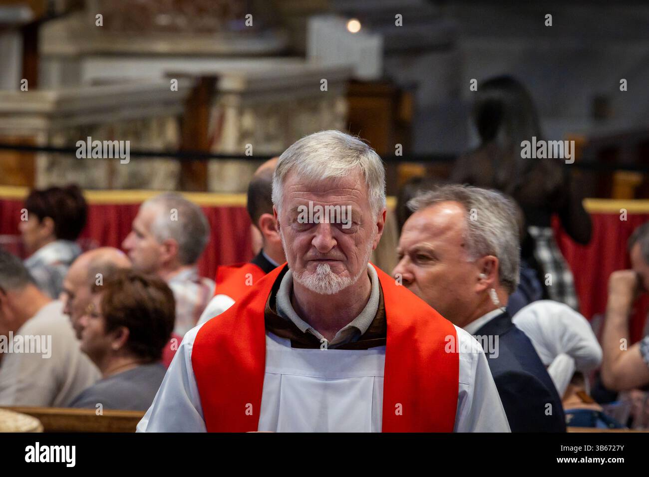 Vatican City - April 30, 2025: Priest during the rite of communion, at ...