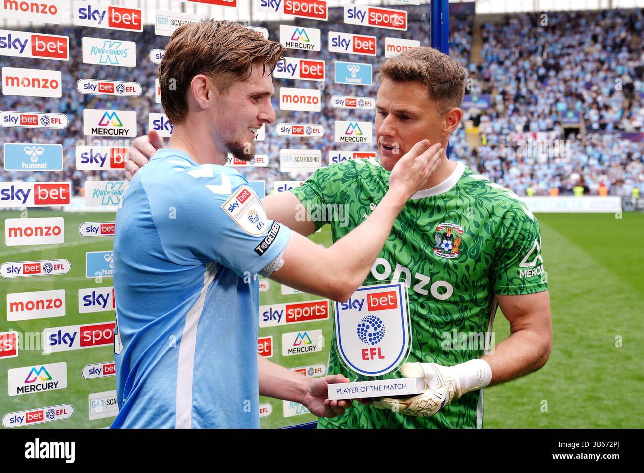 Coventry City's Jack Rudoni (left) recieves the man of the match trophy ...