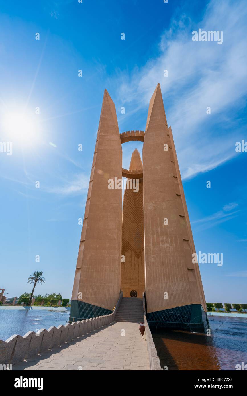 Tourists visit the Soviet Friendship Monument surrounded by palm trees ...