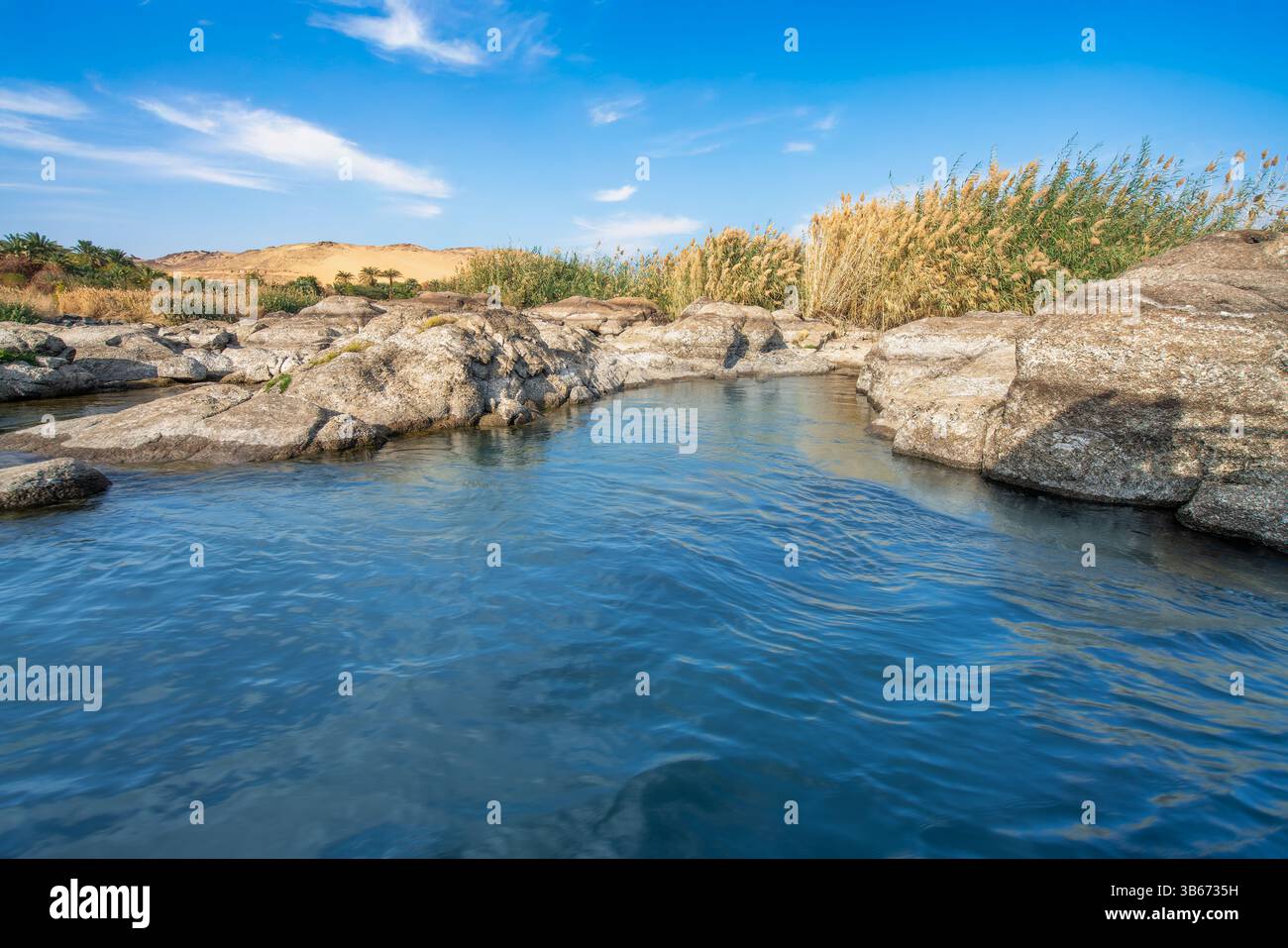 Aswan High Dam, Egypt: A serene Nile River rocky shoreline in spring ...