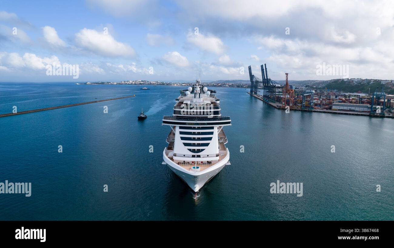 Front view of luxurious cruise ship sailing slowly inside the harbour ...