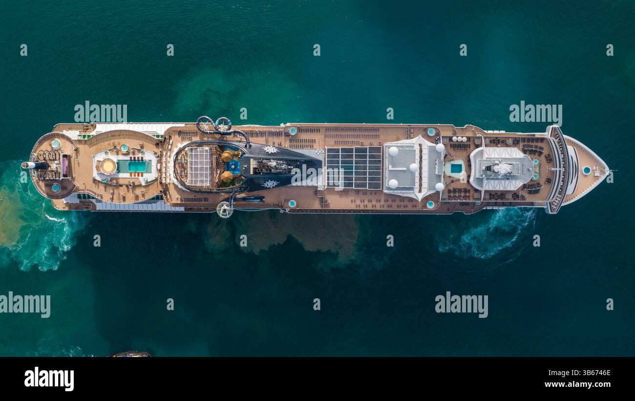 Luxurious cruise ship activating propulsion system for docking maneuver ...