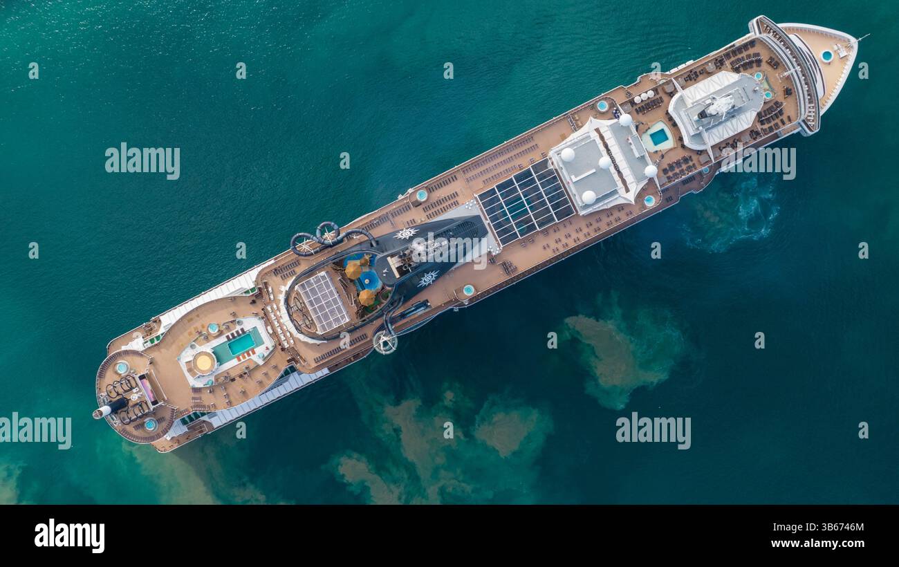 Aerial top down view of cruise ship, passenger ship, maneuvering to ...