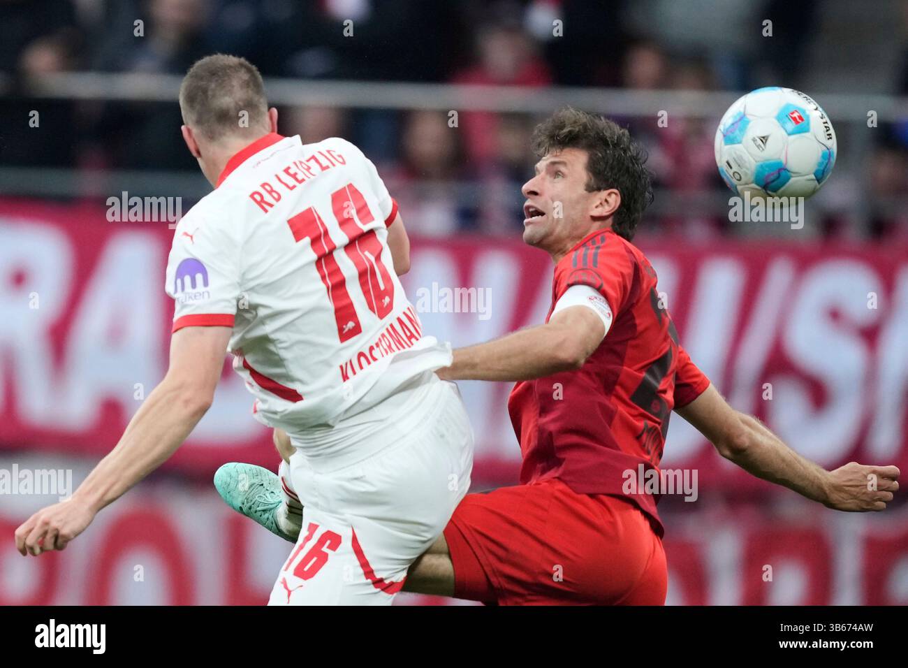 Leipzig's Lukas Klostermann, left, challenges for the ball with Bayern ...
