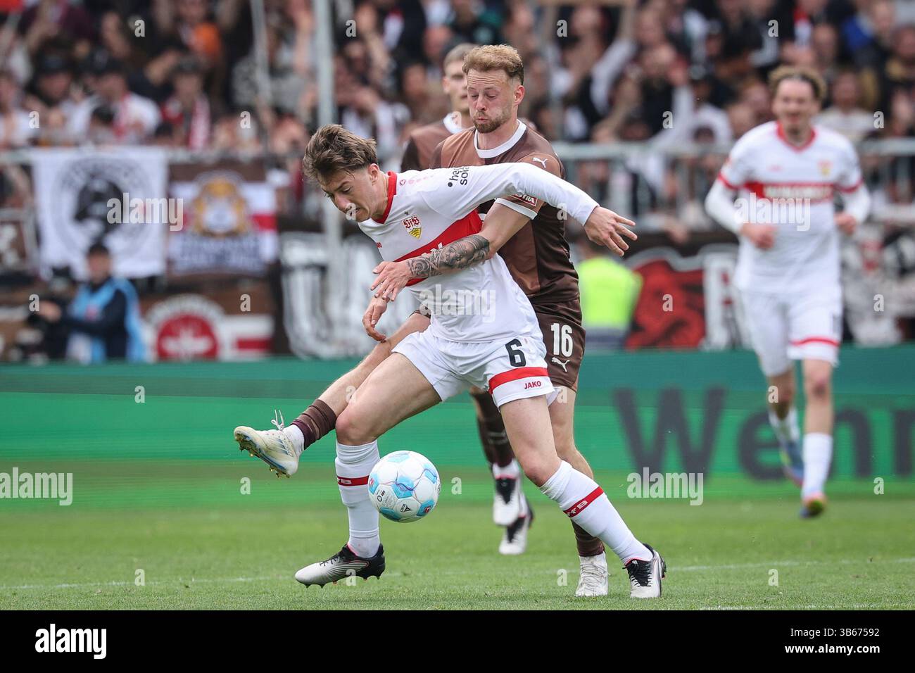 St. Pauli's Carlo Boukhalfa, right, and Stuttgart's Angelo Stiller ...