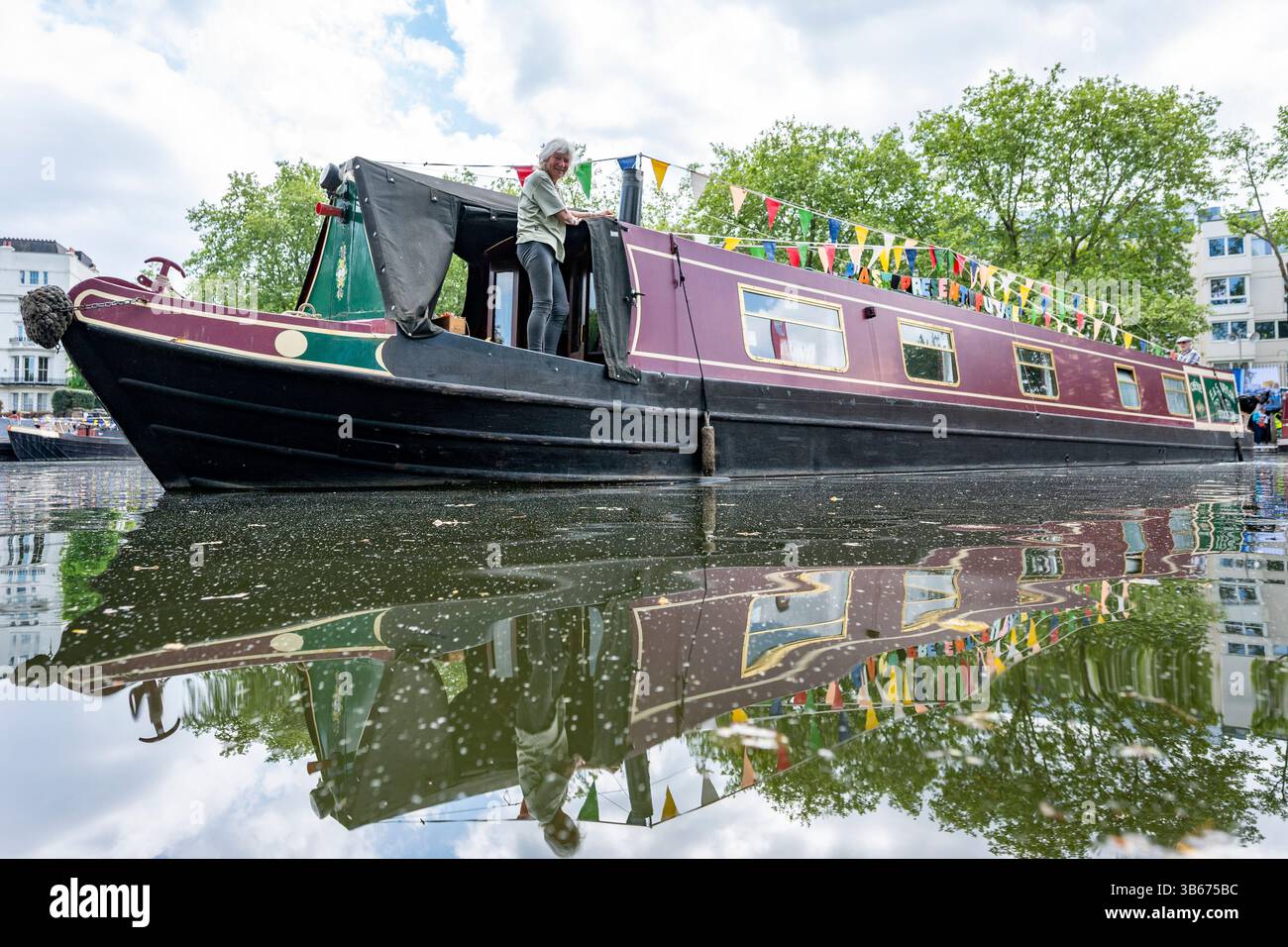 London, UK. 3 May 2025. A narrowboat decked out in colourful bunting ...