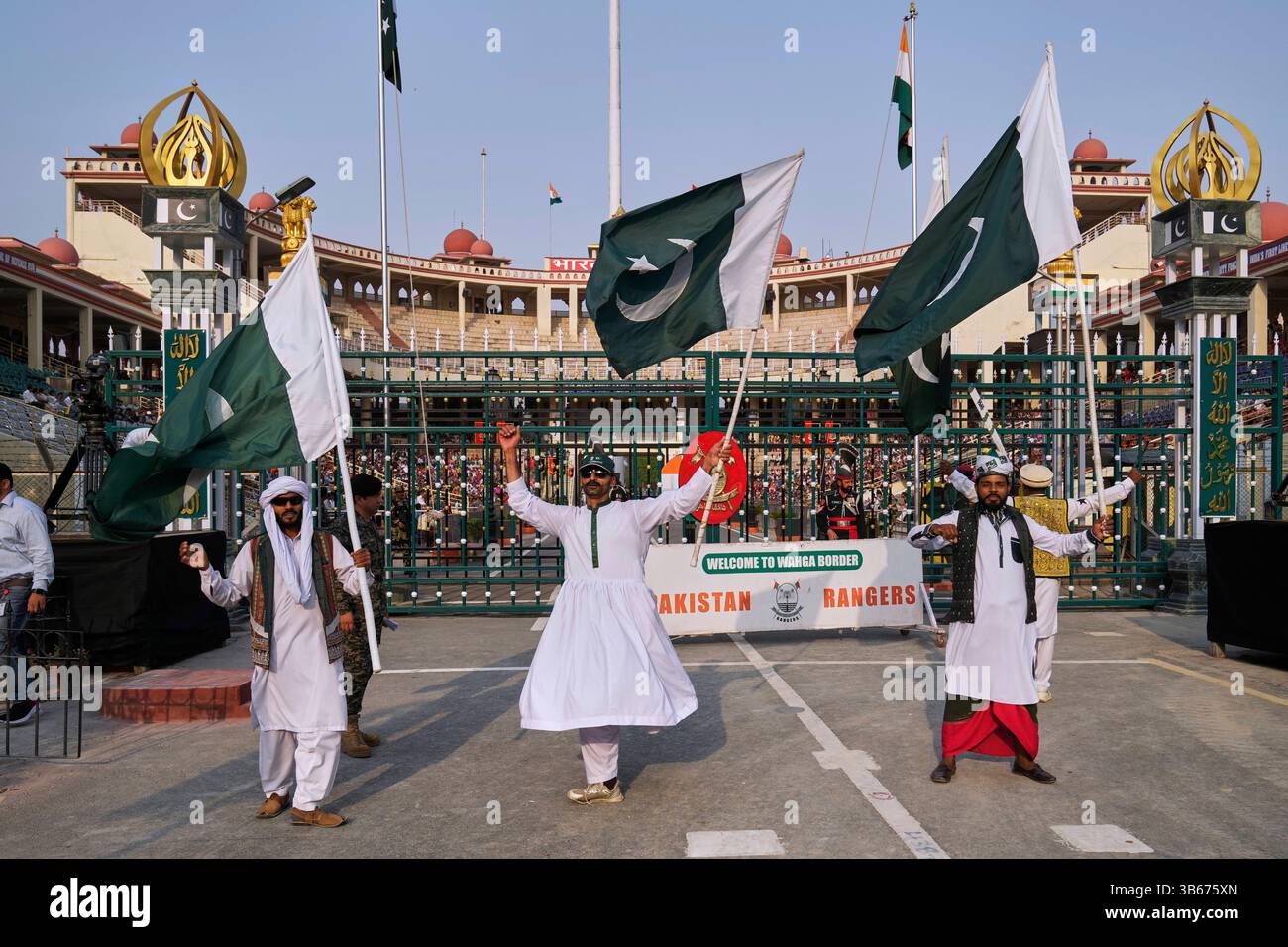 Pakistan's folk dancers perform with national flag during a daily ...