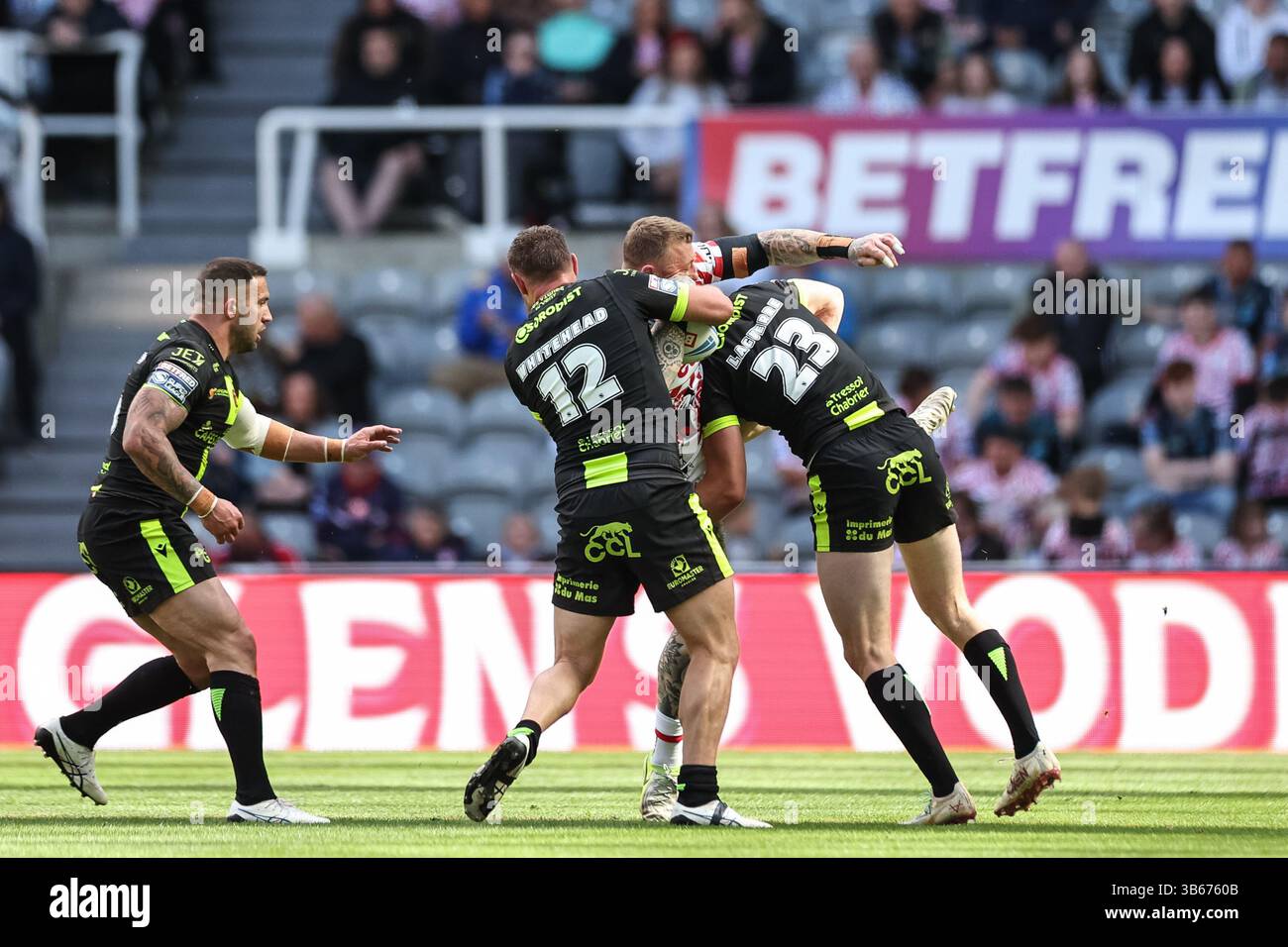 Josh Charley of Leigh Leopards is tackled by Elliott Whitehead of ...