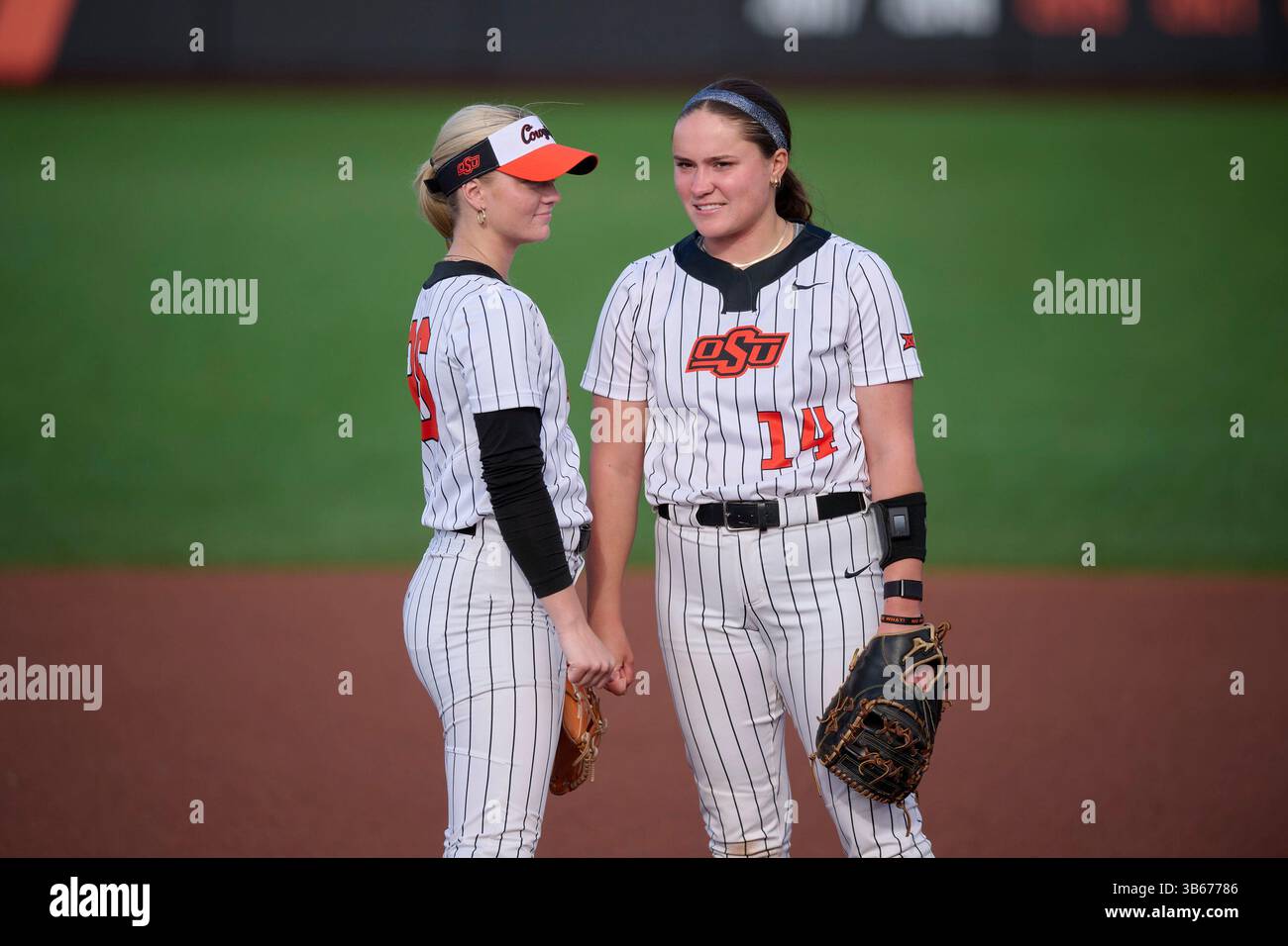 Oklahoma State Cowgirls second baseman Rosie Davis (26) talks with ...