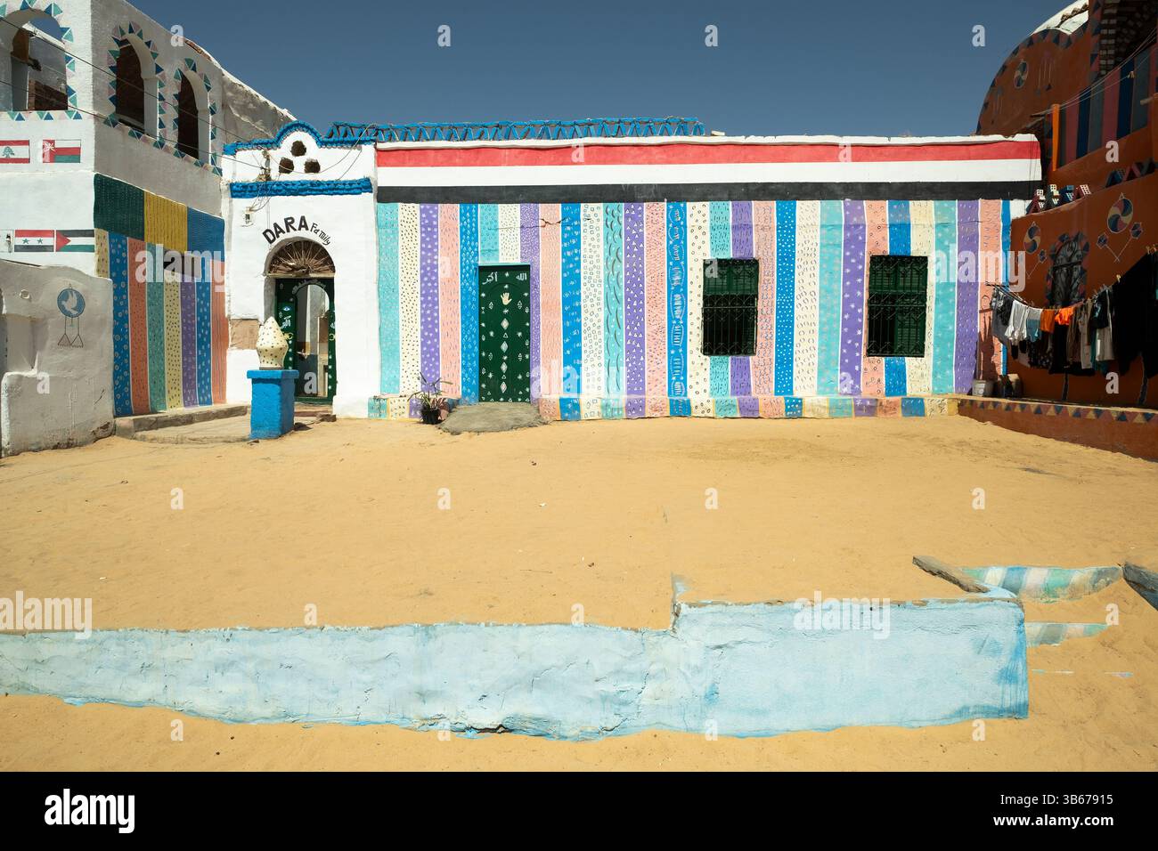 Brightly painted nubian house stands in a village near Aswan, Egypt ...