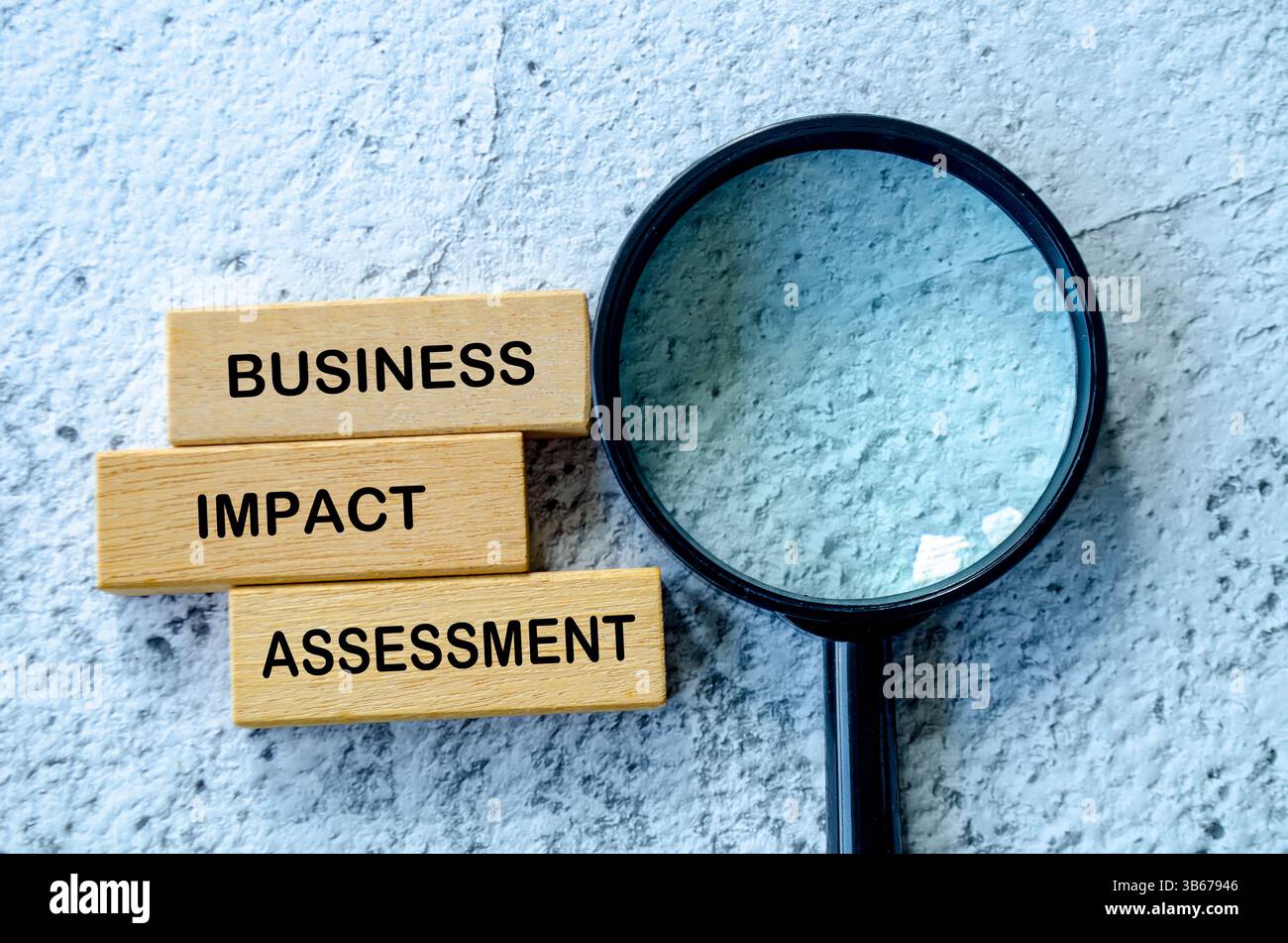 Top view of Business Impact Assessment text on wooden blocks with ...