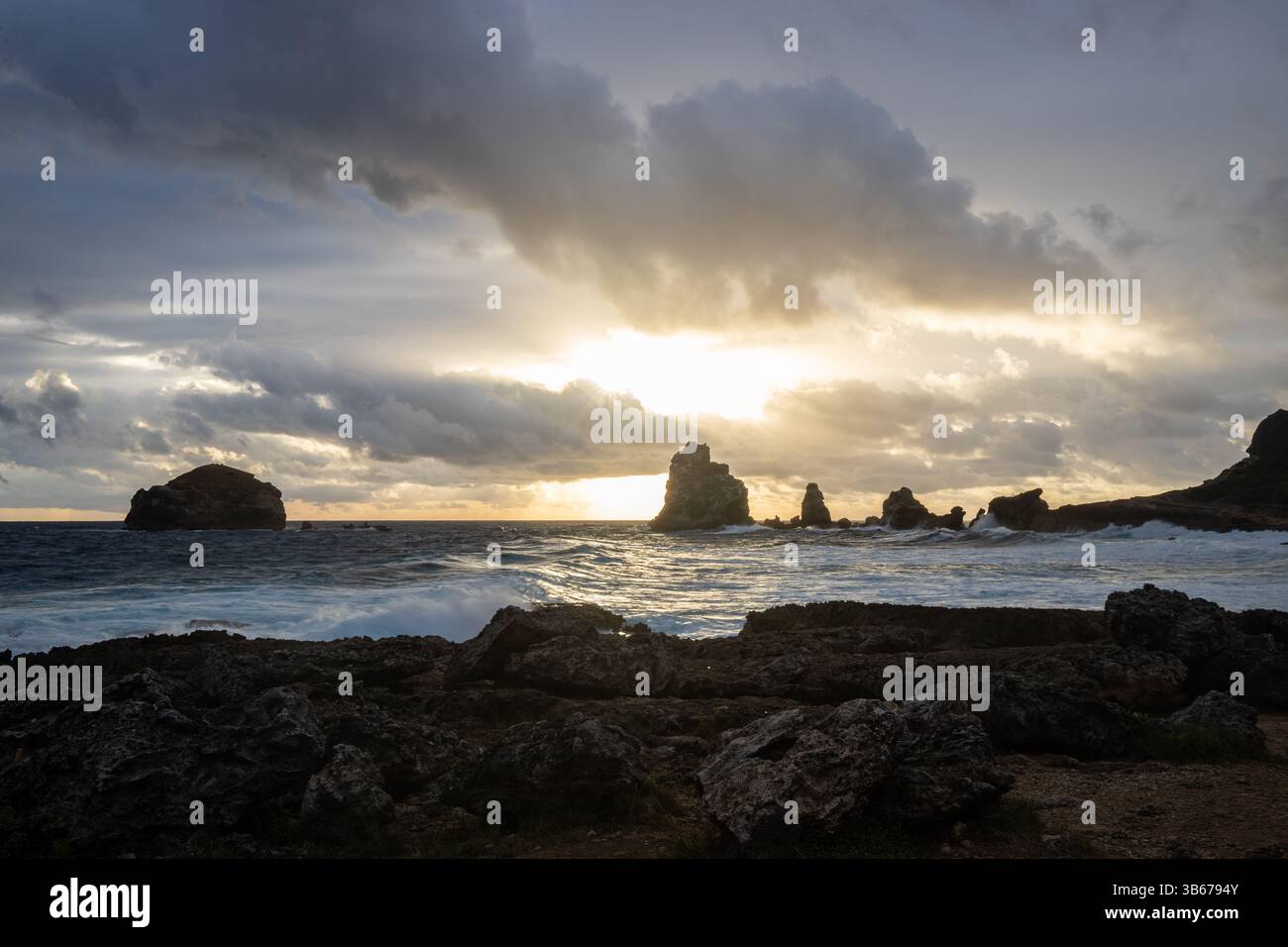 Rocky coast with sharp rock formations at a bay in the sea. Dramatic ...
