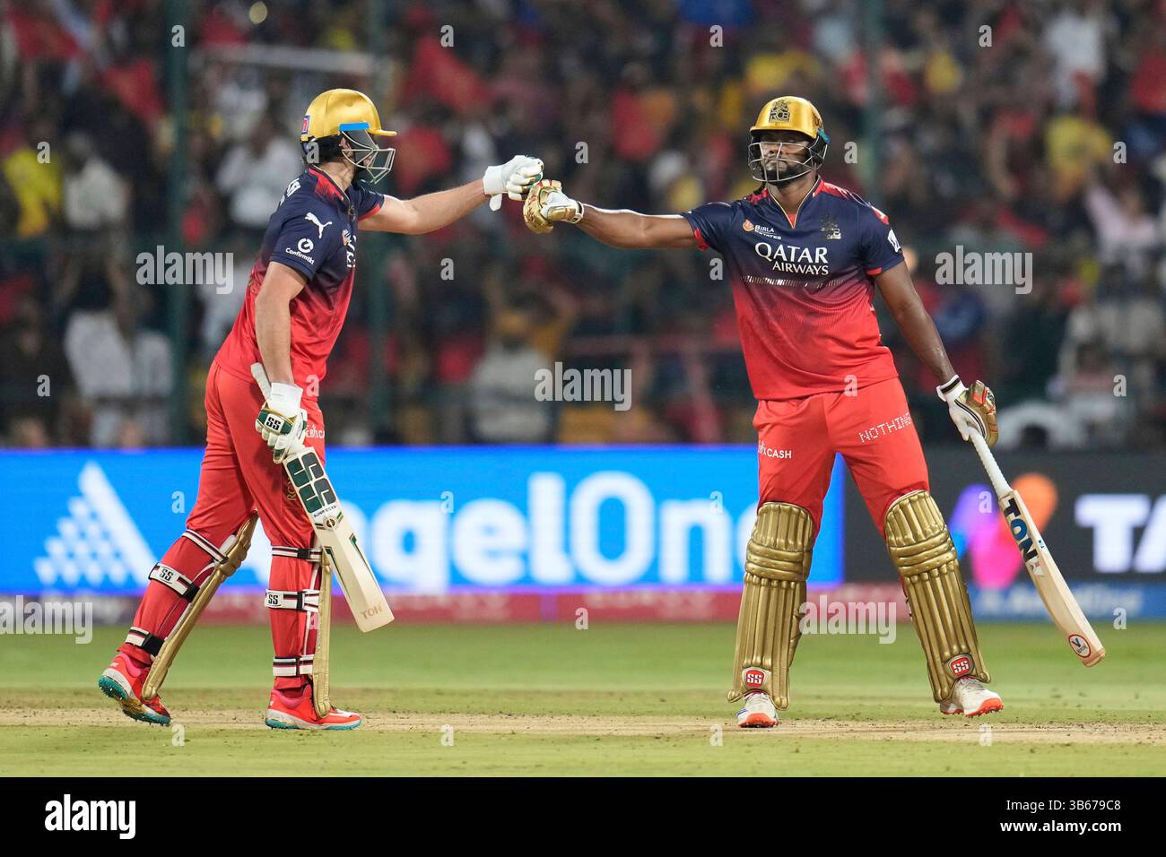 Royal Challengers Bengaluru's Romario Shepherd, right, celebrates with ...
